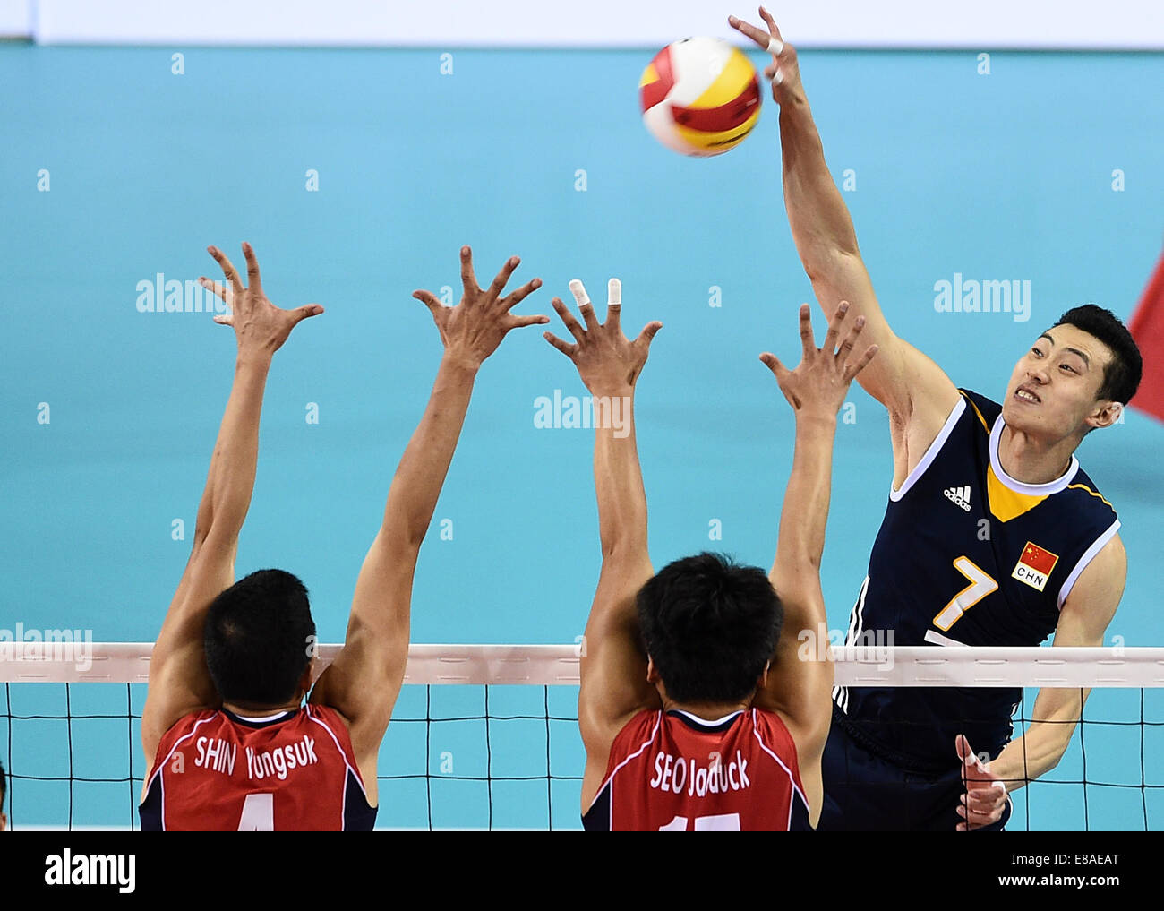 Incheon, South Korea. 3rd Oct, 2014. Zhong Weijun (R) of China spikes during the men's bronze ...