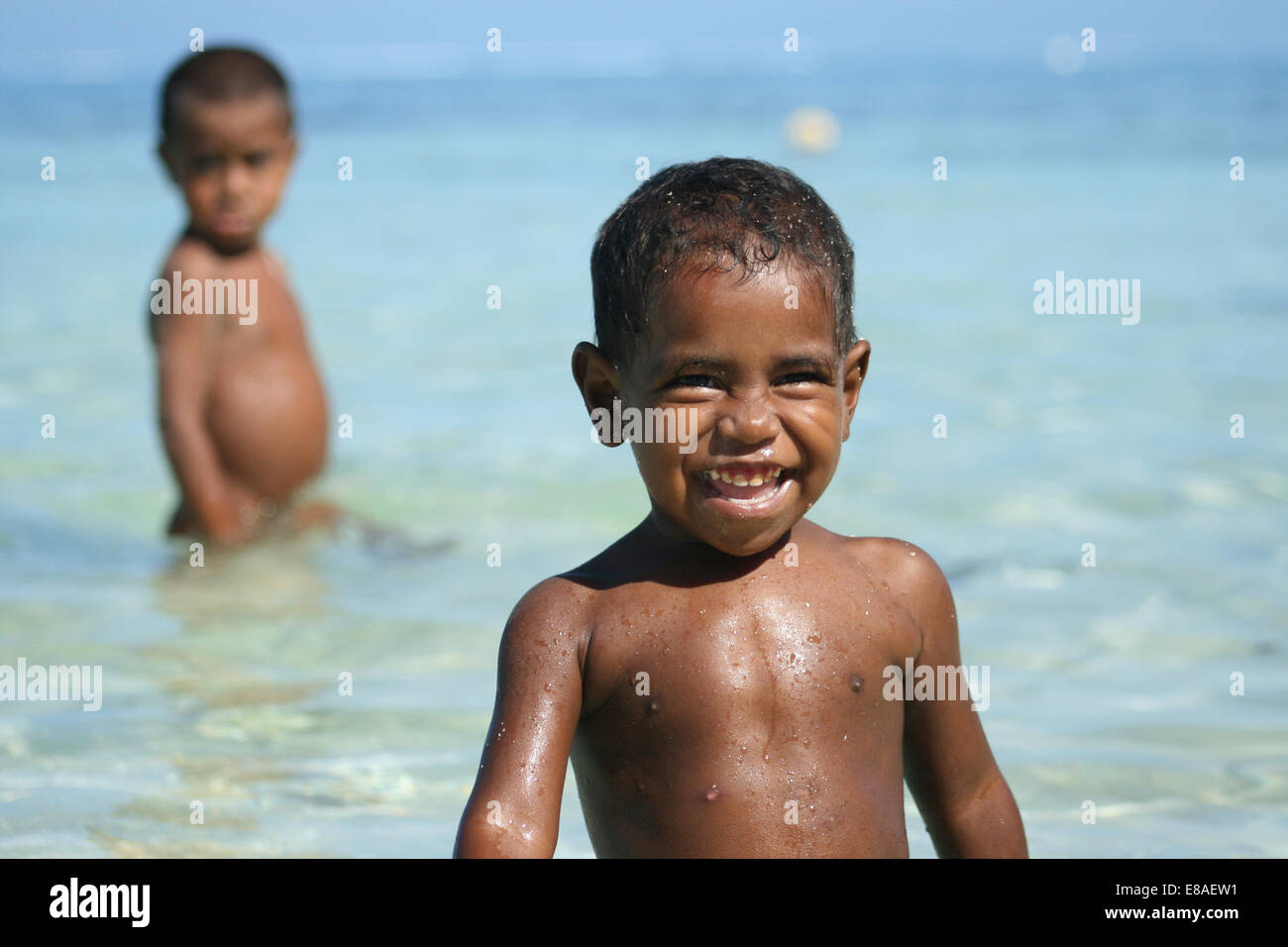 Fiji boys in the turquoise sea Stock Photo - Alamy