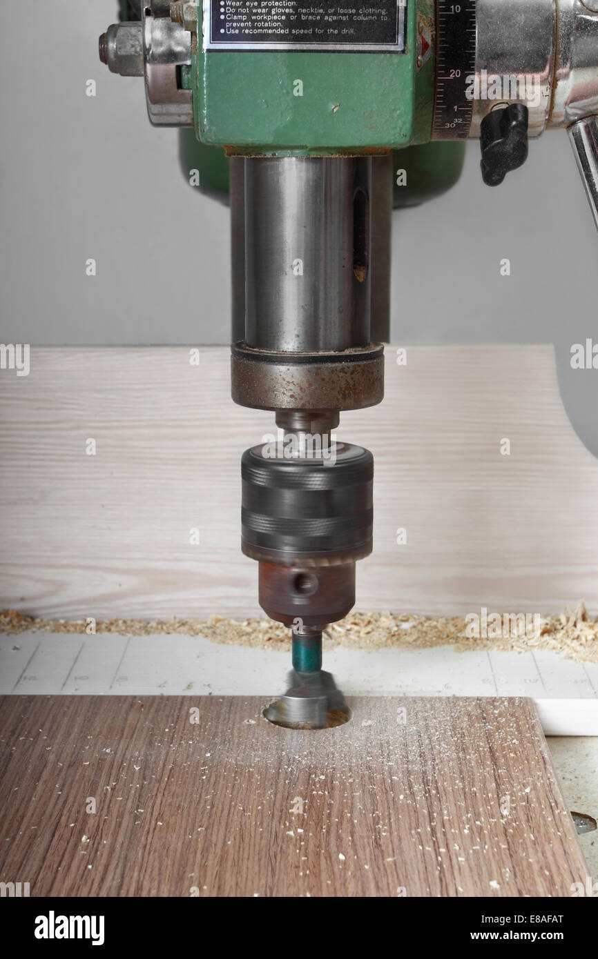Rotating drill machine make aperture in wooden panel Stock Photo - Alamy
