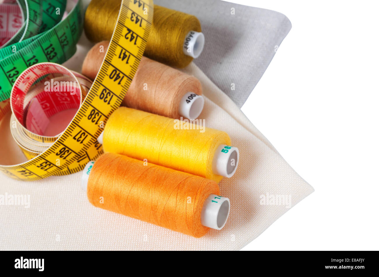 Yellow spools of thread and measuring tape Stock Photo - Alamy