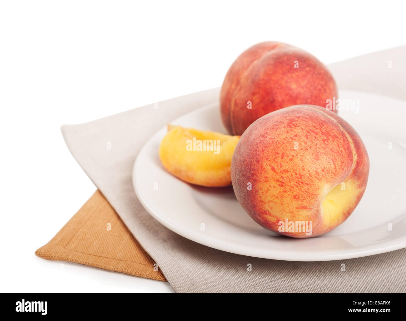 Ripe juicy peach on a white plate Stock Photo - Alamy