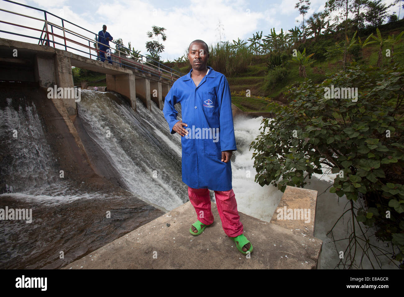 Technicians inspect dam upstream of hydro electric powerplant, Rwanda ...