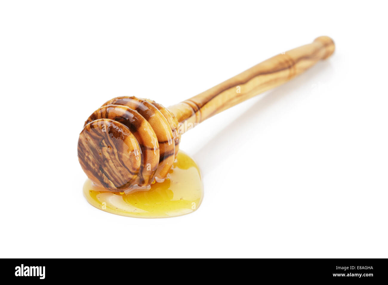 olive dipper with pure maple honey, start to crystallize isolated on ...
