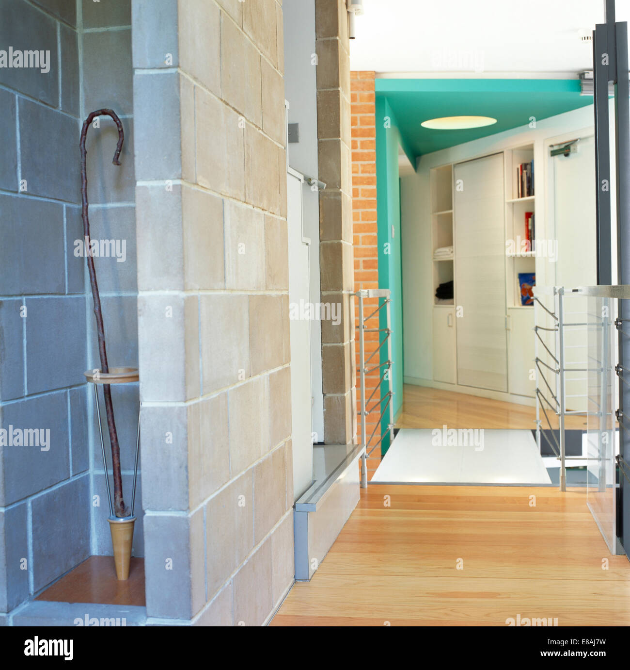 Breeze-block wall and wooden flooring in modern hall Stock Photo - Alamy