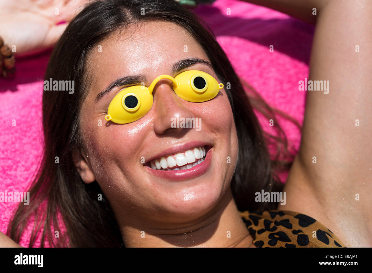 Portrait of young woman sunbathing, wearing goggles Stock Photo - Alamy
