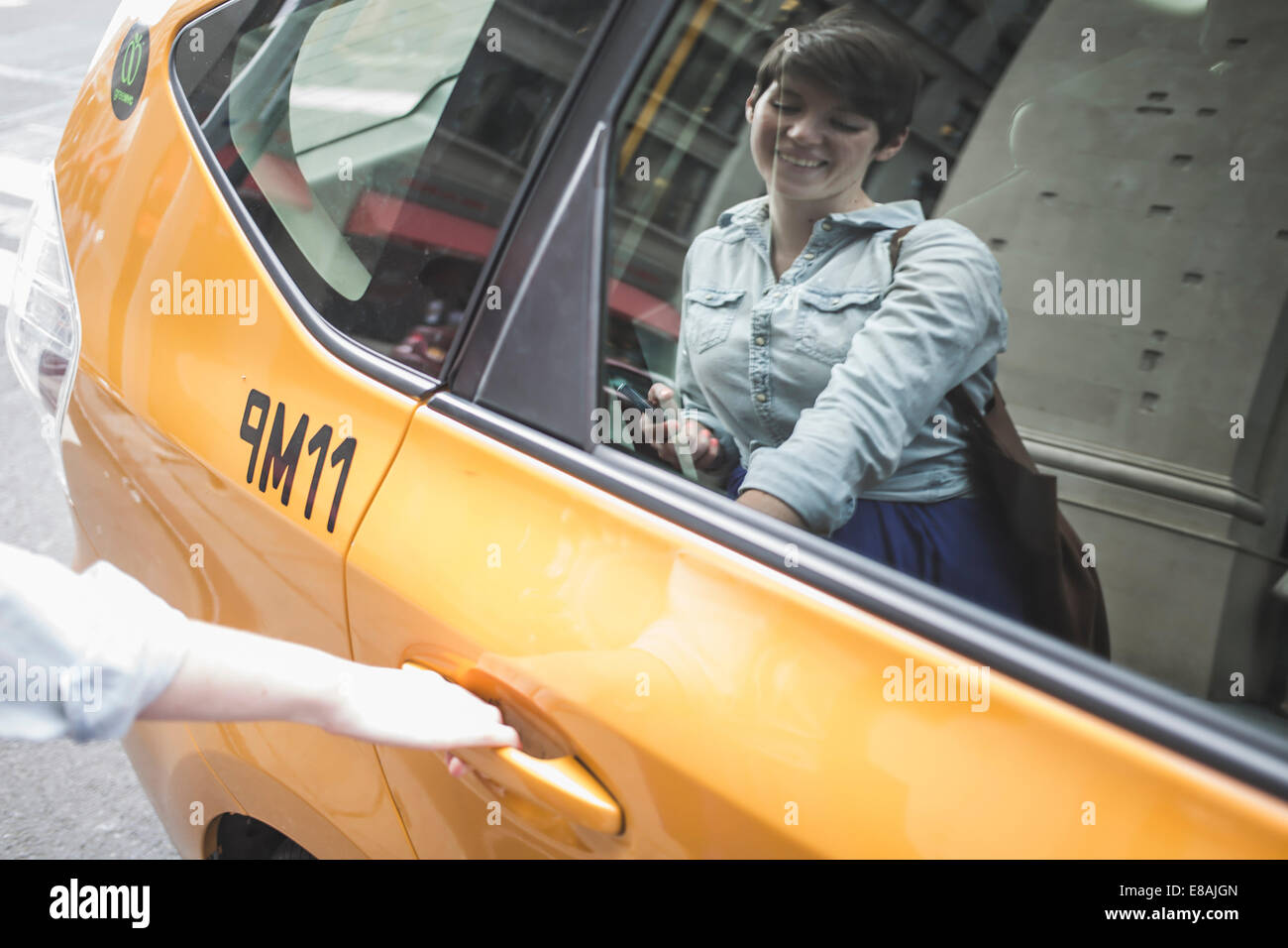 Woman getting into taxi hi-res stock photography and images - Alamy