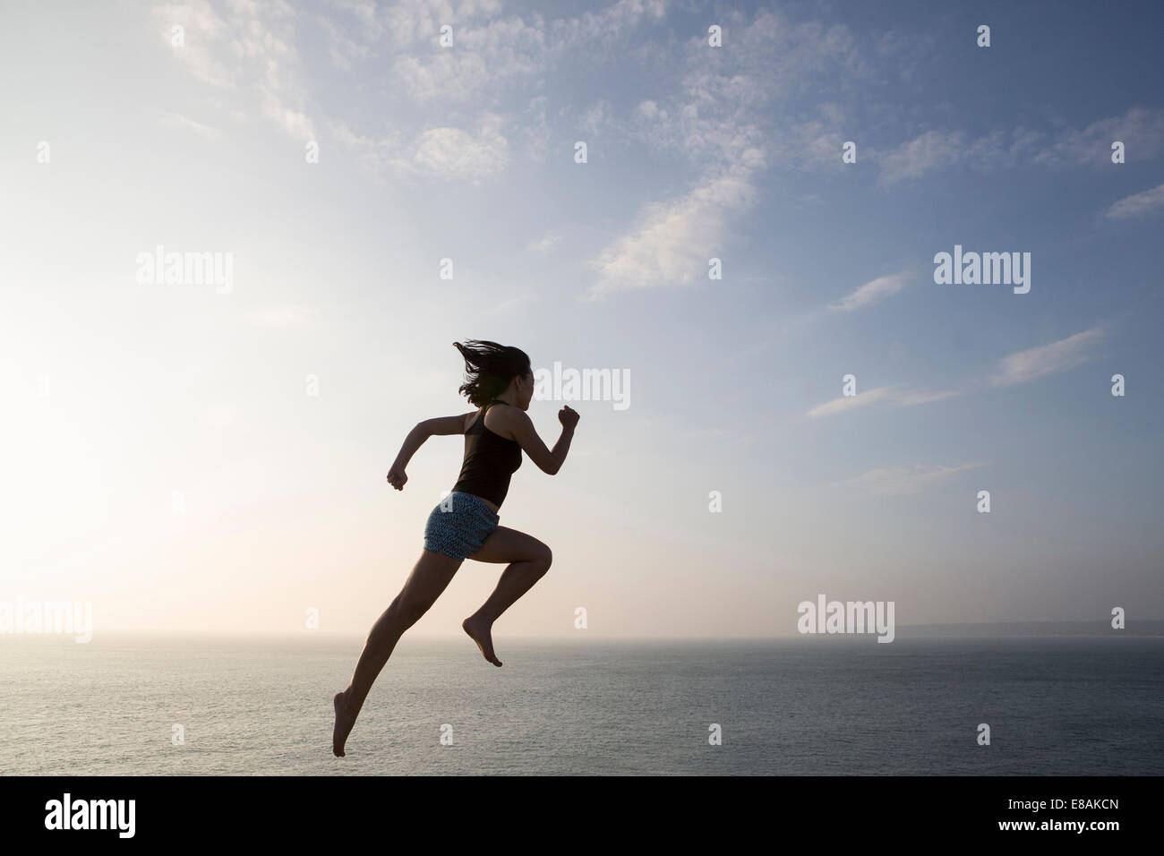 Woman jumping against skyline Stock Photo - Alamy
