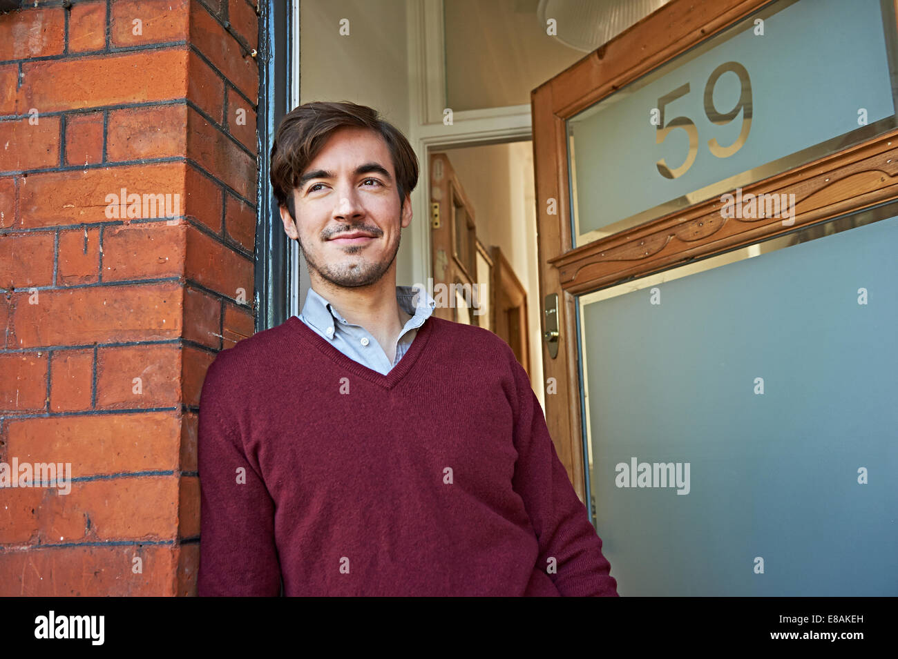 Man standing by front door Stock Photo - Alamy
