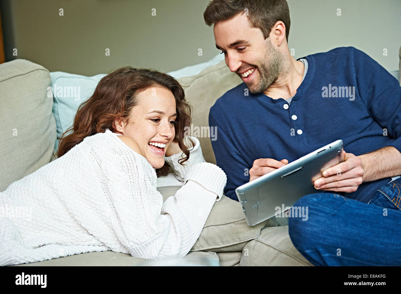 Couple chilling on sofa Stock Photo - Alamy