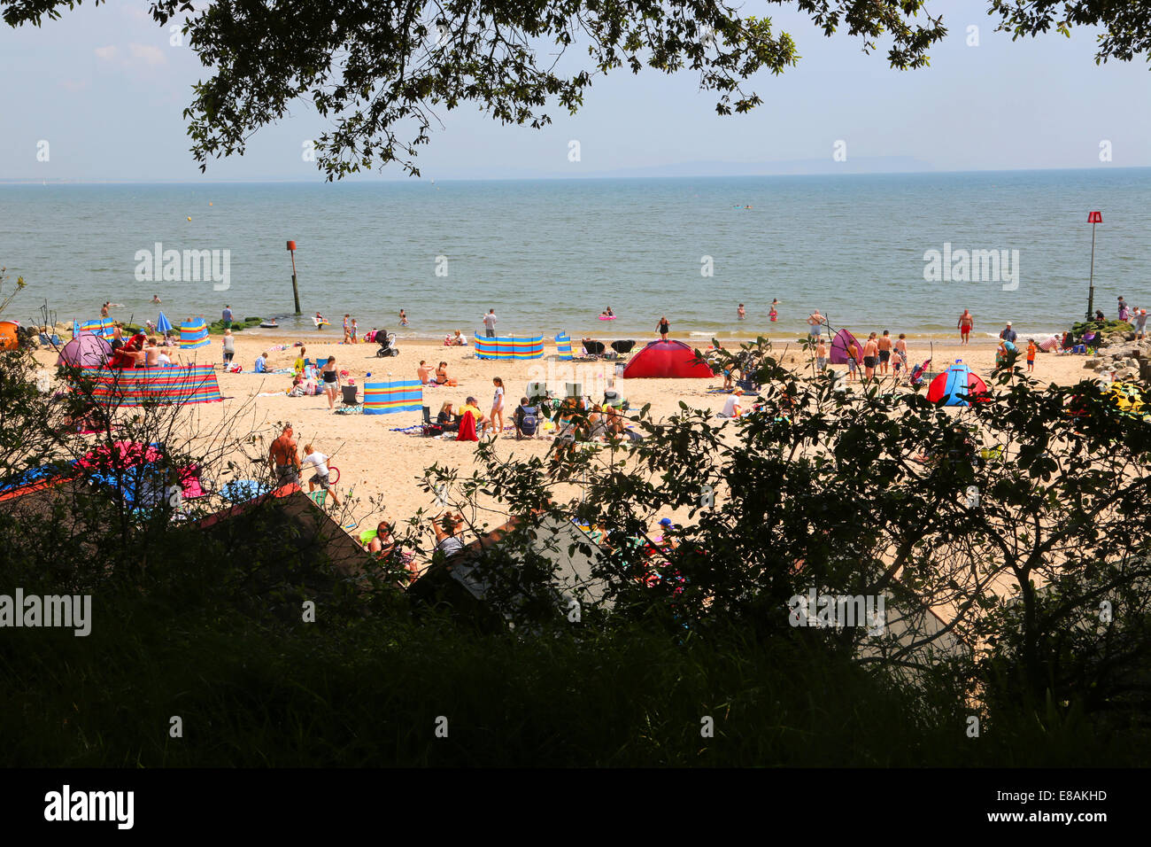 View Through Trees Of People On Avon Beach Mudeford Dorset England ...