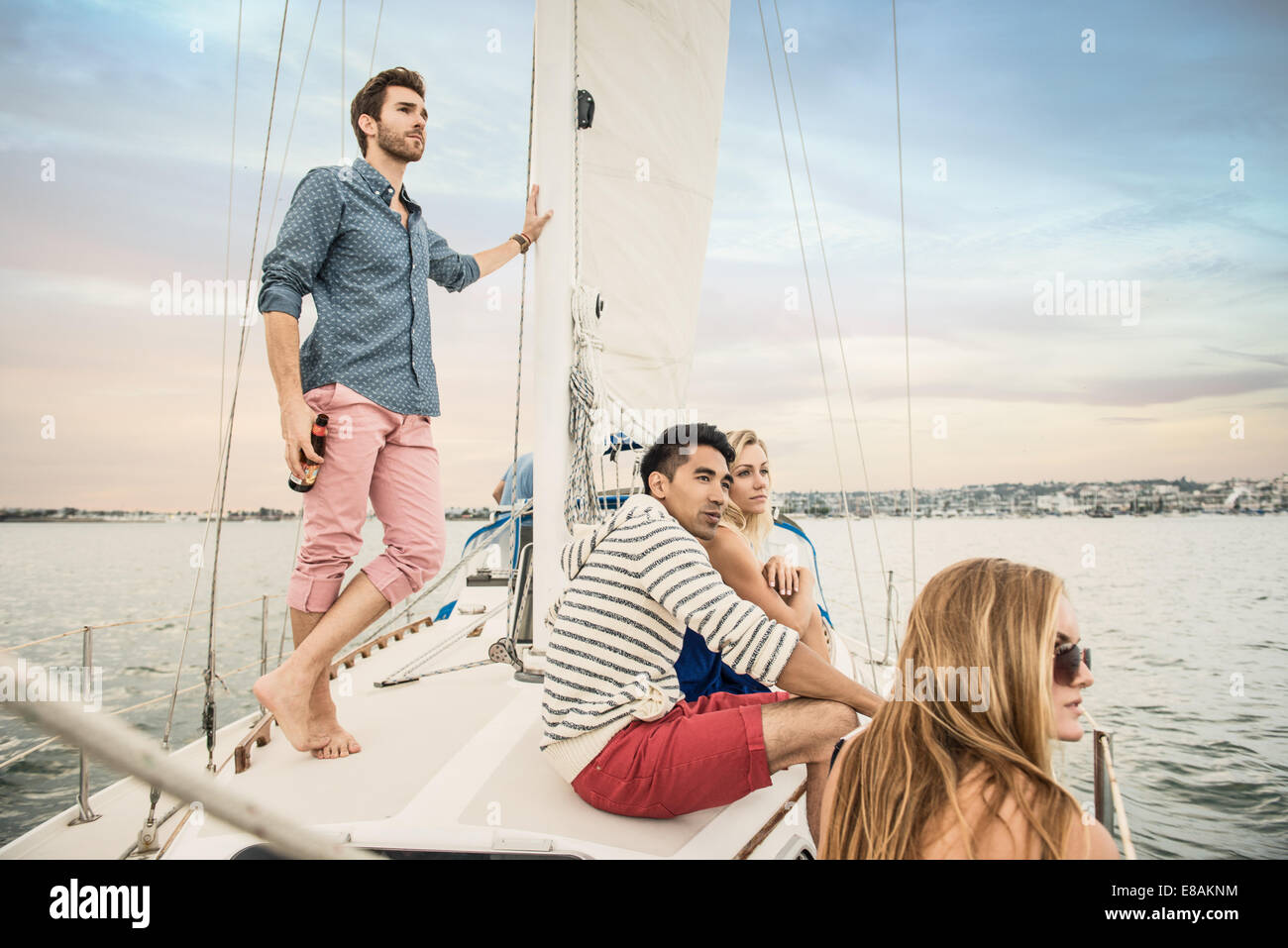 Friends on sailing boat looking at view Stock Photo - Alamy
