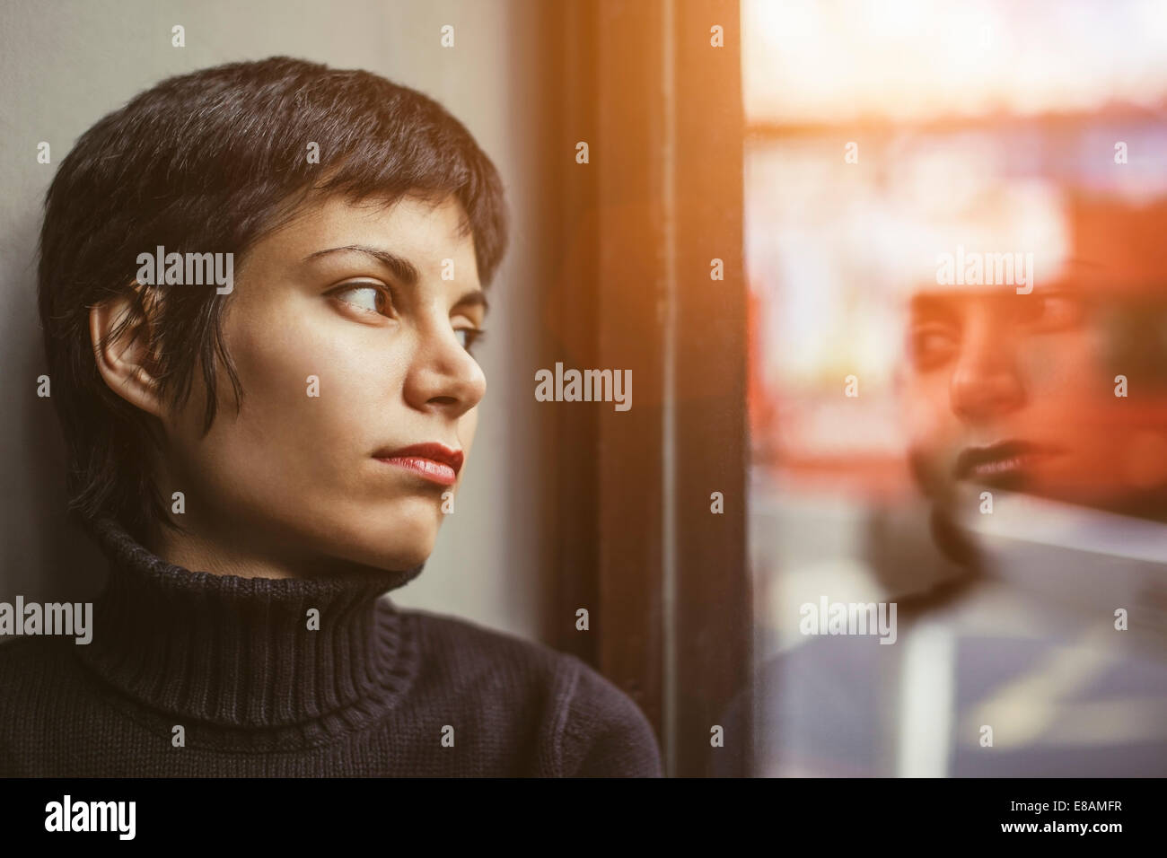 Woman staring out through window hi-res stock photography and images ...