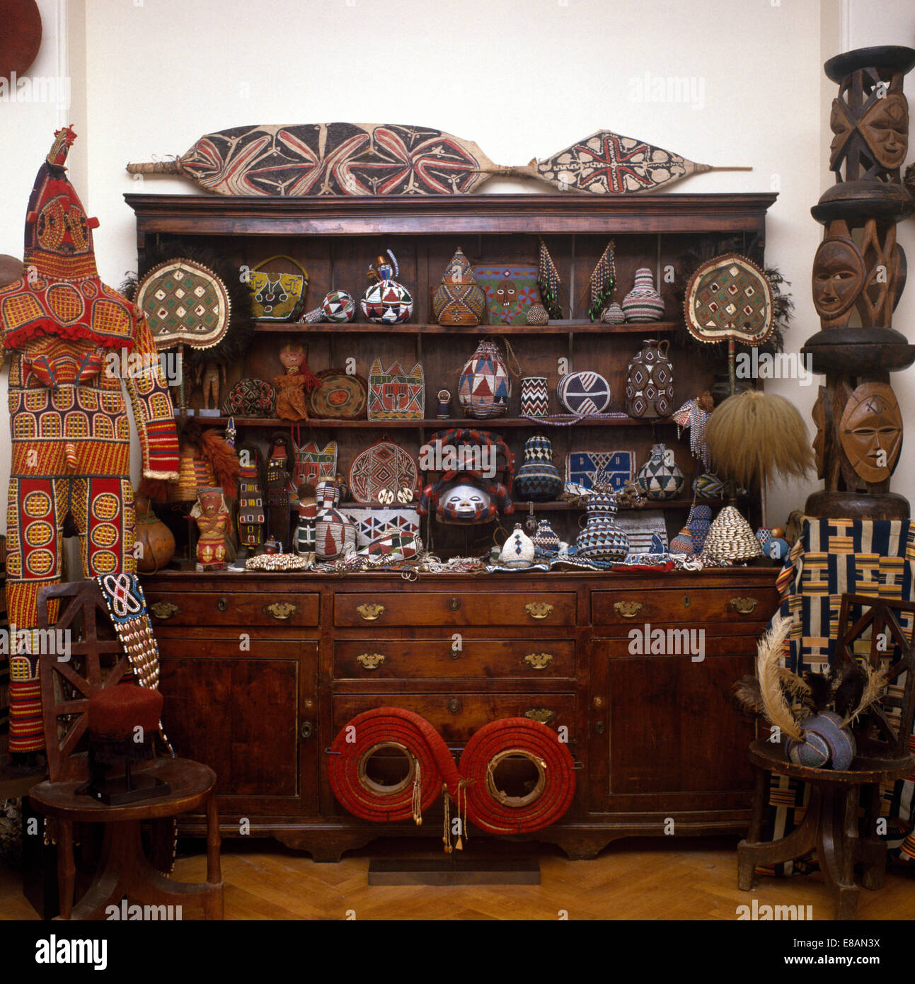 Large antique dresser with collection of ethnic artwork and artefacts ...