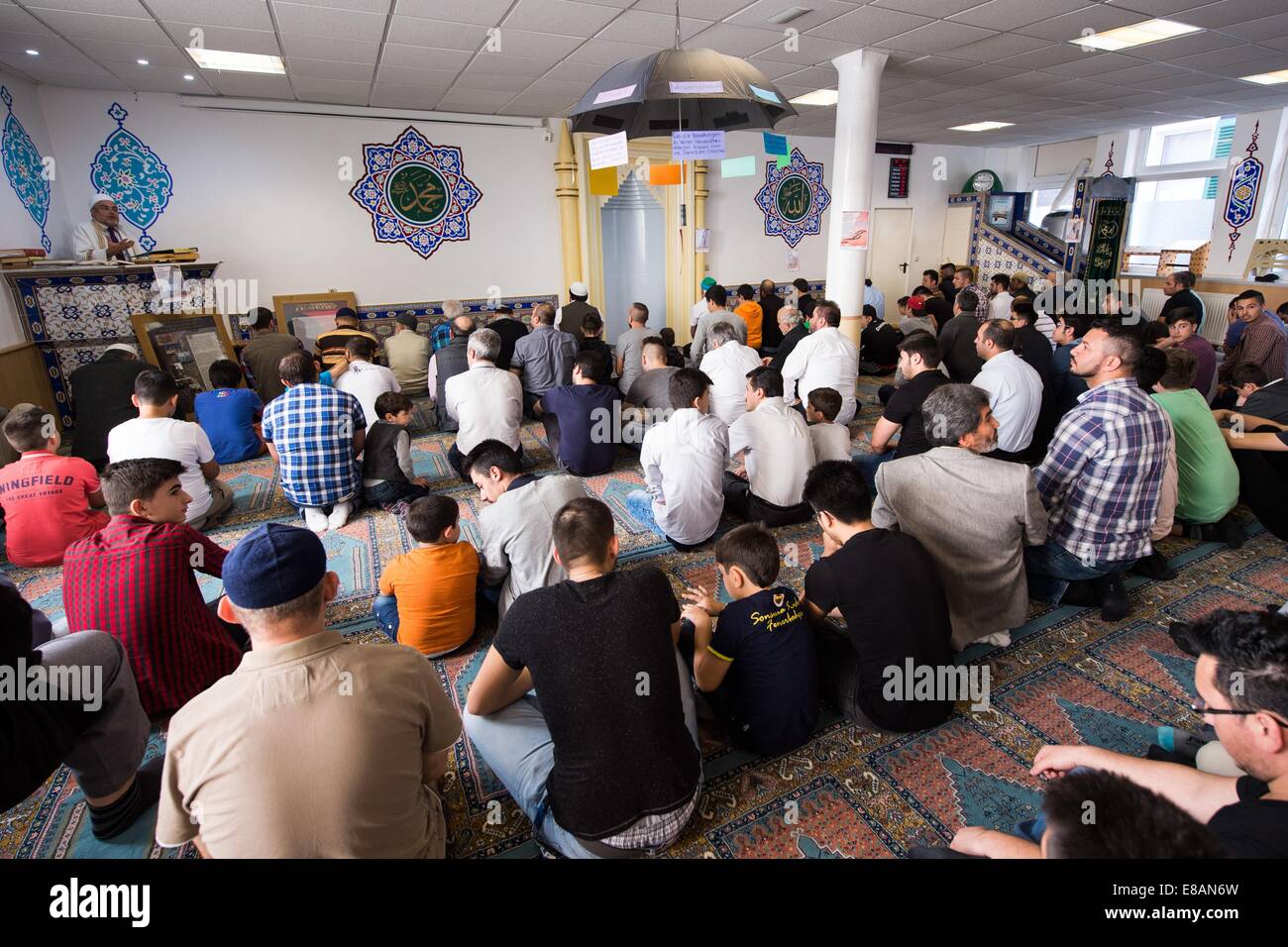 People wait for during Friday prayers in a mosque in Wuppertal, Germany ...