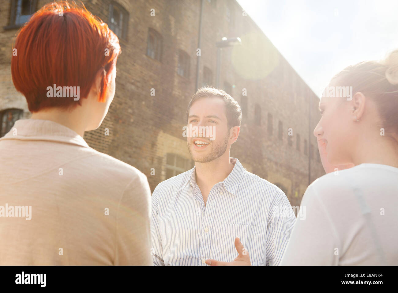 Three people talking hi-res stock photography and images - Alamy