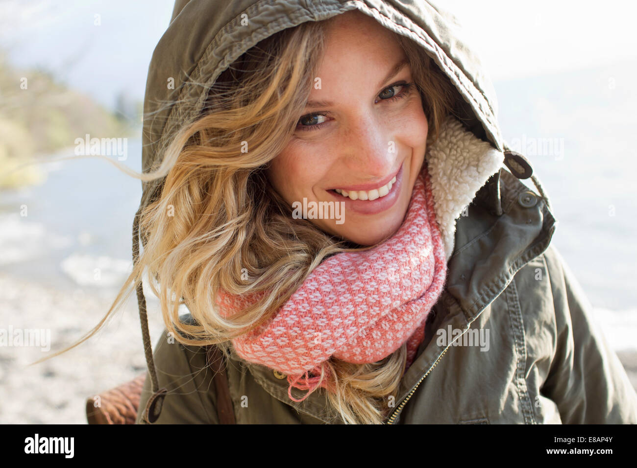 Woman all wrapped up on windy beach Stock Photo - Alamy