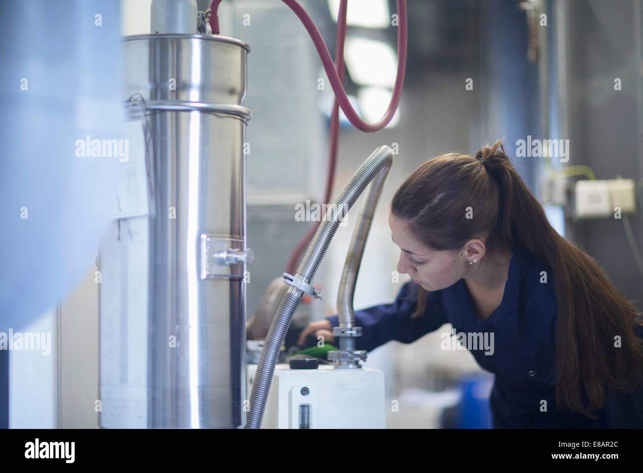 Female engineer inspecting industrial piping in factory Stock Photo - Alamy