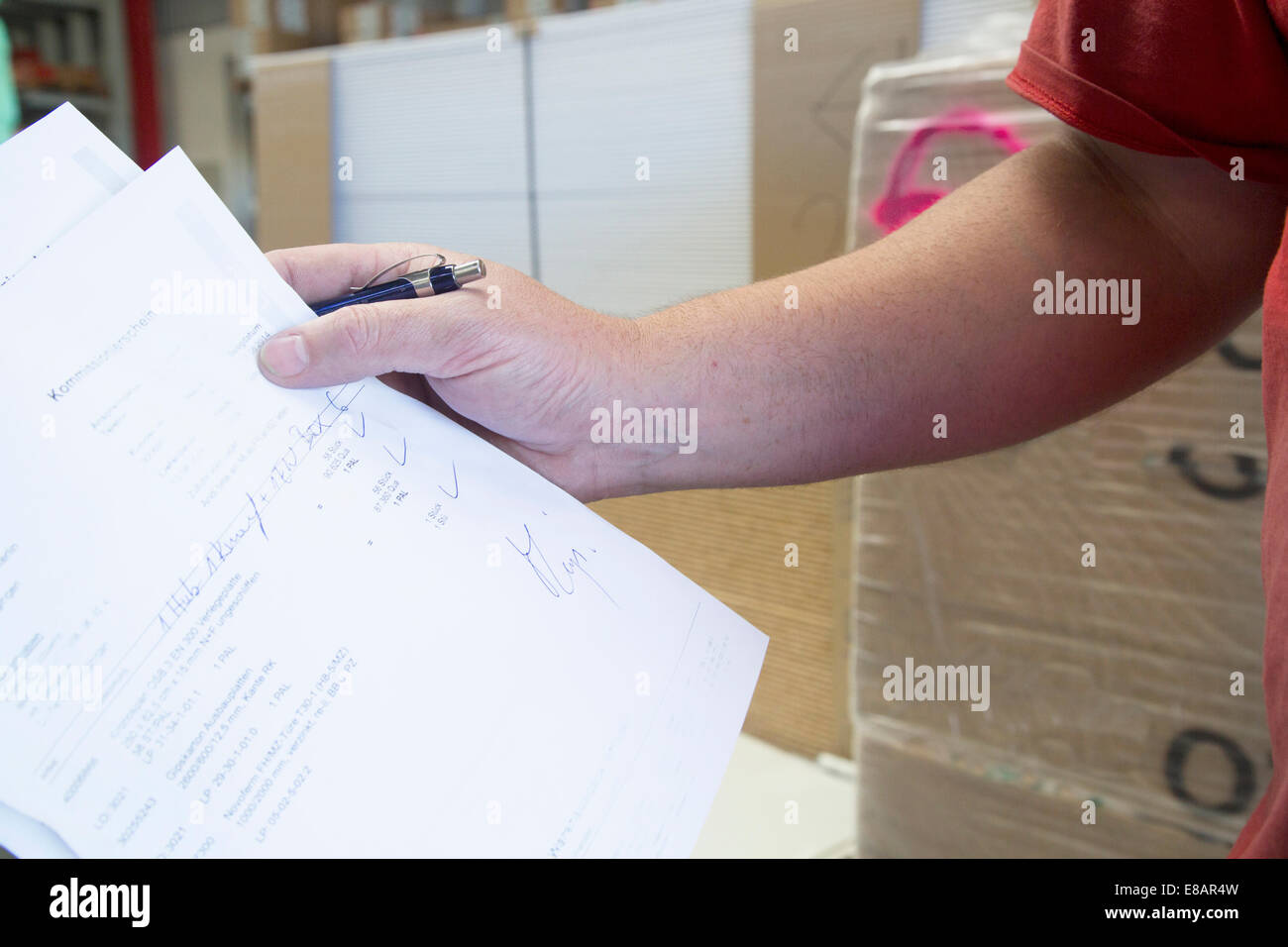 Hand of male warehouse worker collecting order for hardware store Stock ...