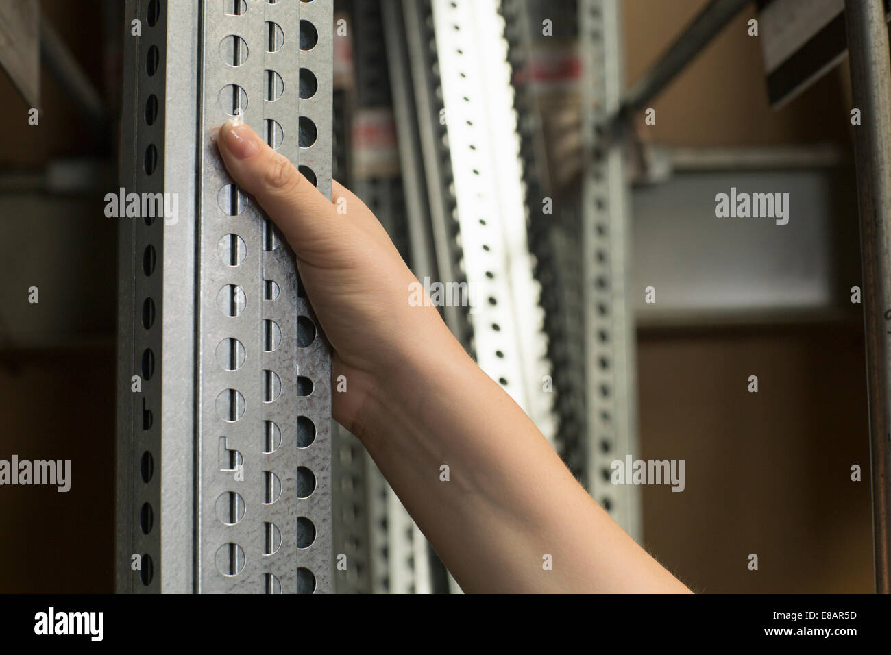 Hand of female customer selecting metal bars in hardware store Stock ...