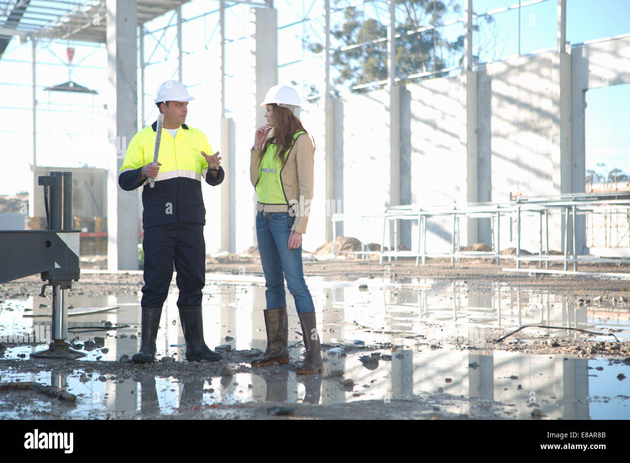 Site manager and architect chatting on construction site Stock Photo ...