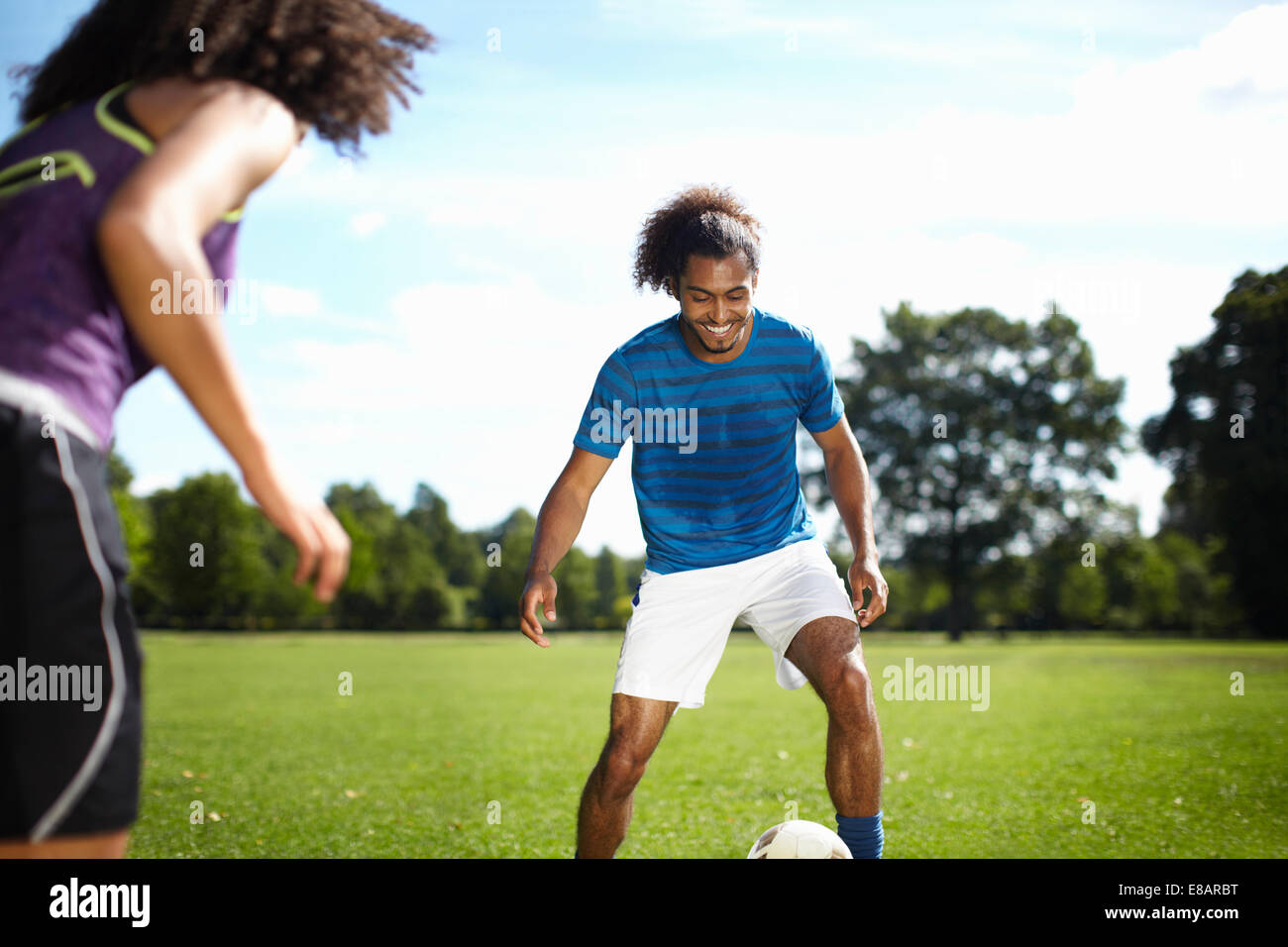Adults playing soccer in the park hi-res stock photography and images ...