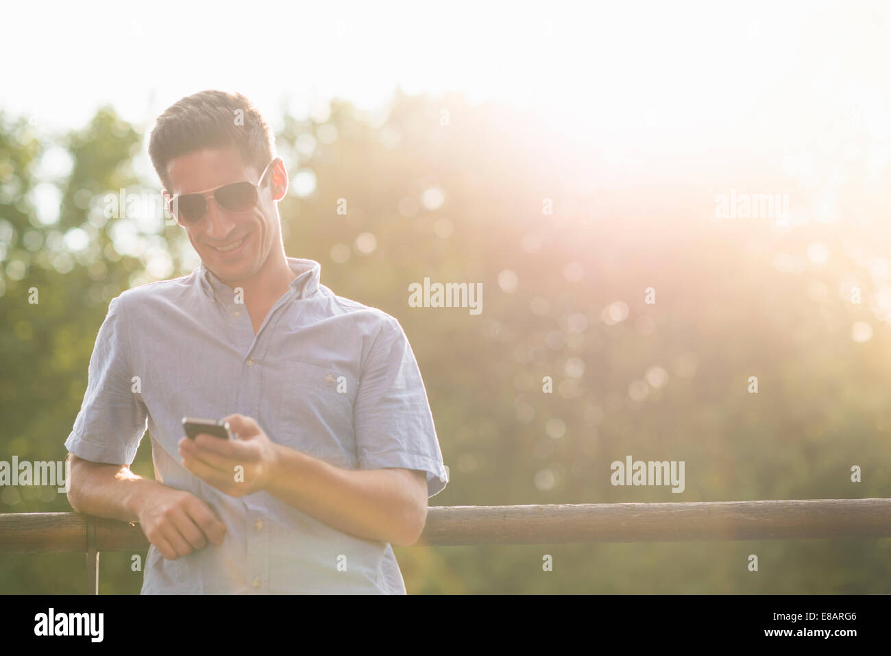 Young man using cell phone Stock Photo - Alamy