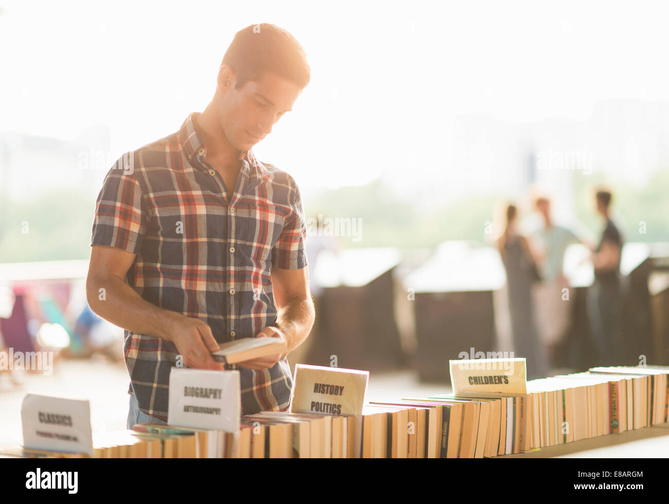 Young man at second hand book stall Stock Photo - Alamy
