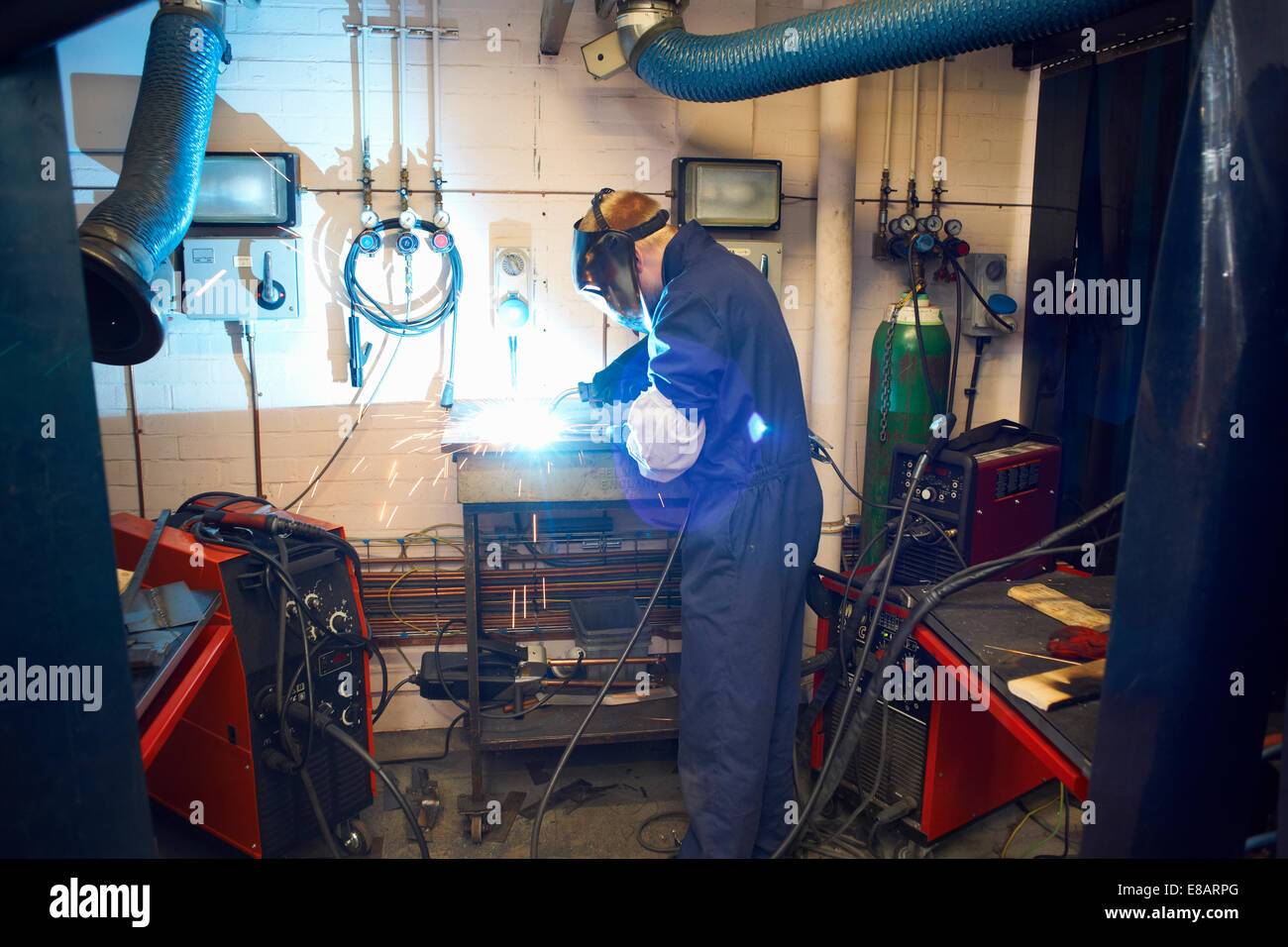 Male student welder welding in college workshop Stock Photo - Alamy