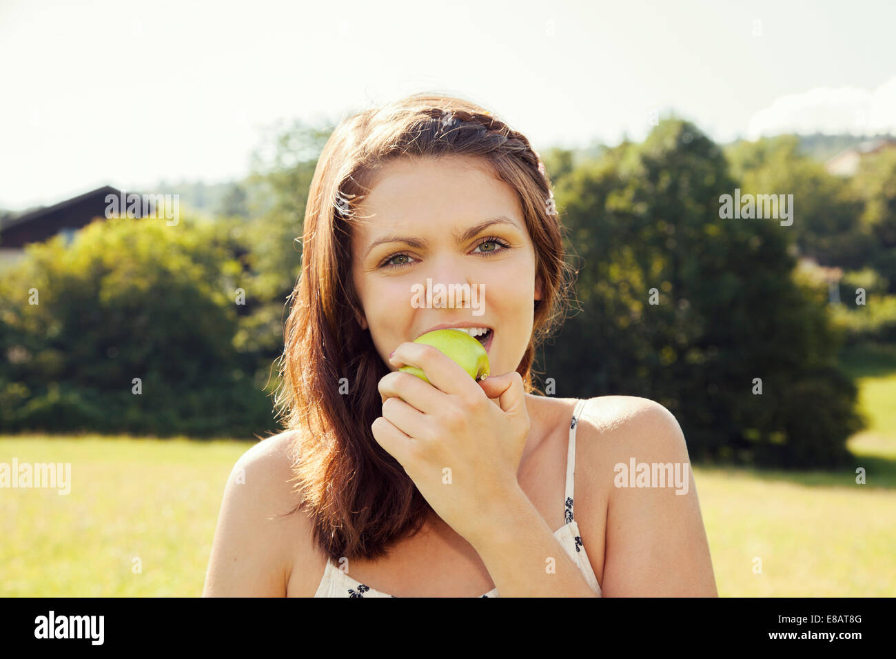 Young woman biting apple Stock Photo - Alamy
