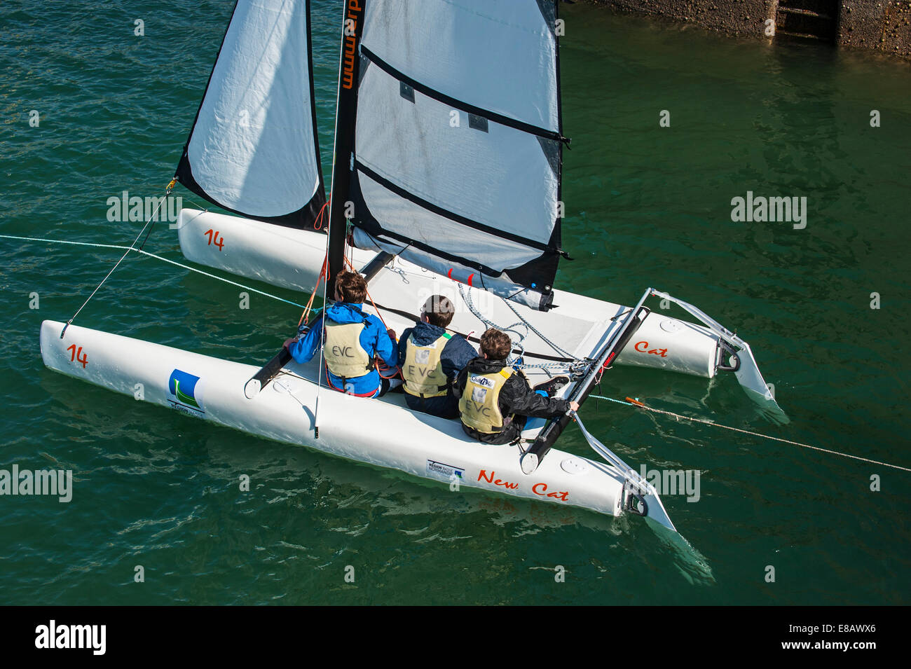 School children on catamaran learning to sail during sailing class at ...