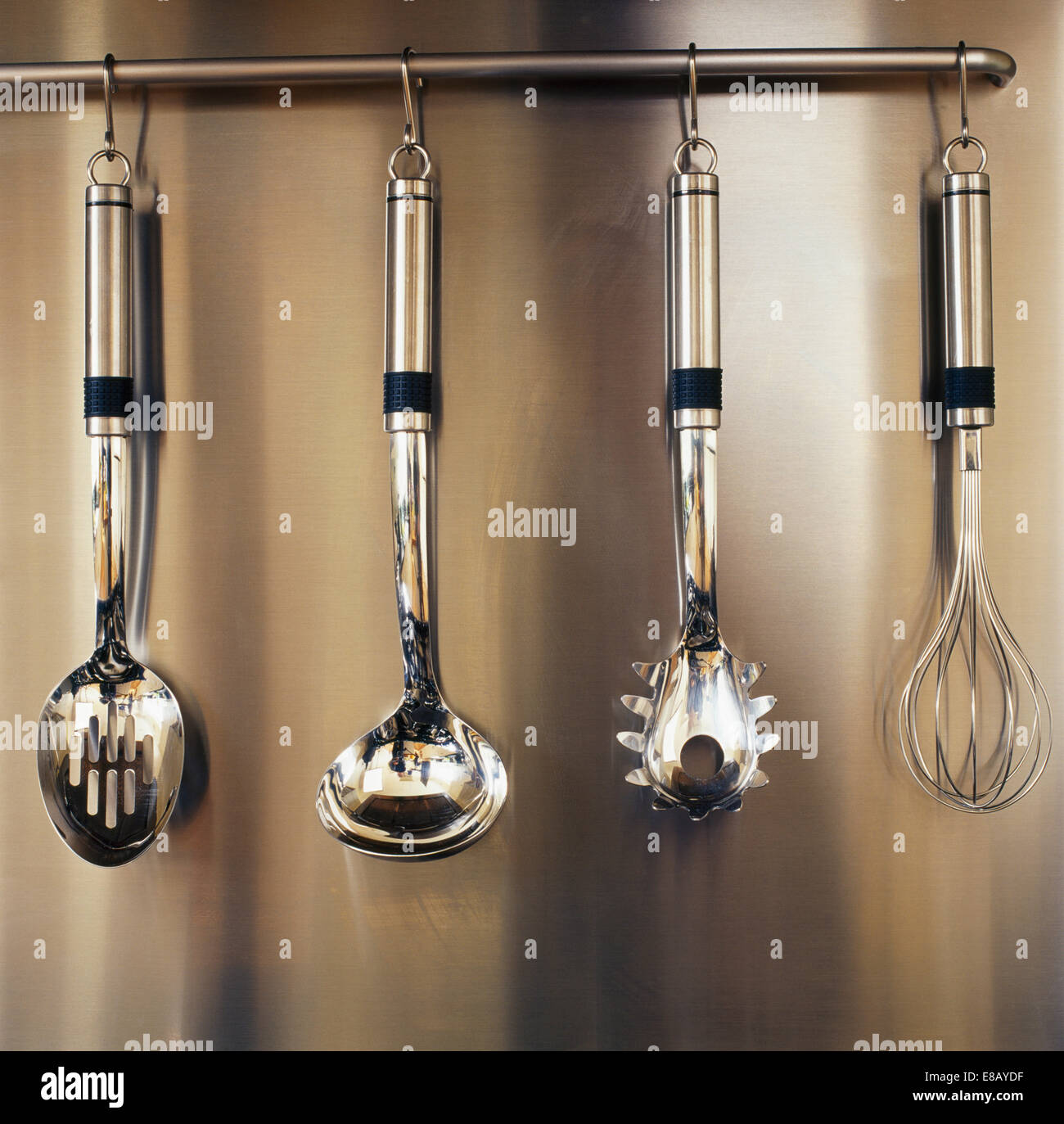 Close-up of stainless-steel spoons and whisk on storage bar Stock Photo ...