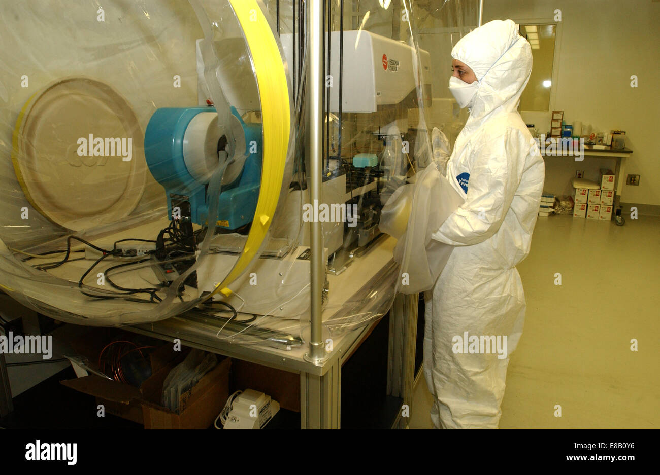 Technician working at biosafety protective hood. National Human Genome ...