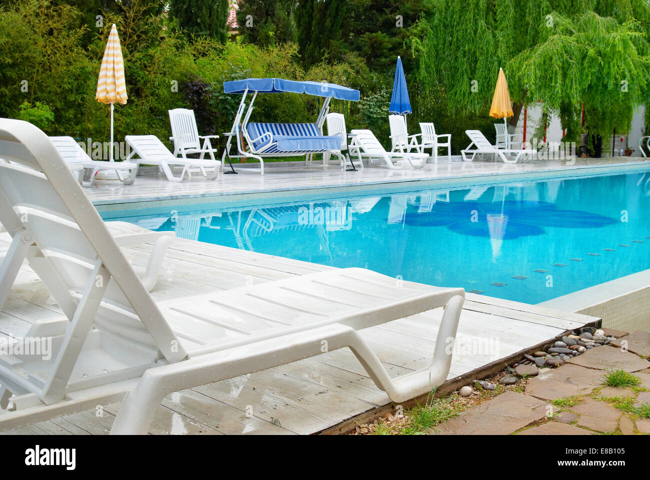 Swimming pool in the hotel with blue relaxing water Stock Photo - Alamy