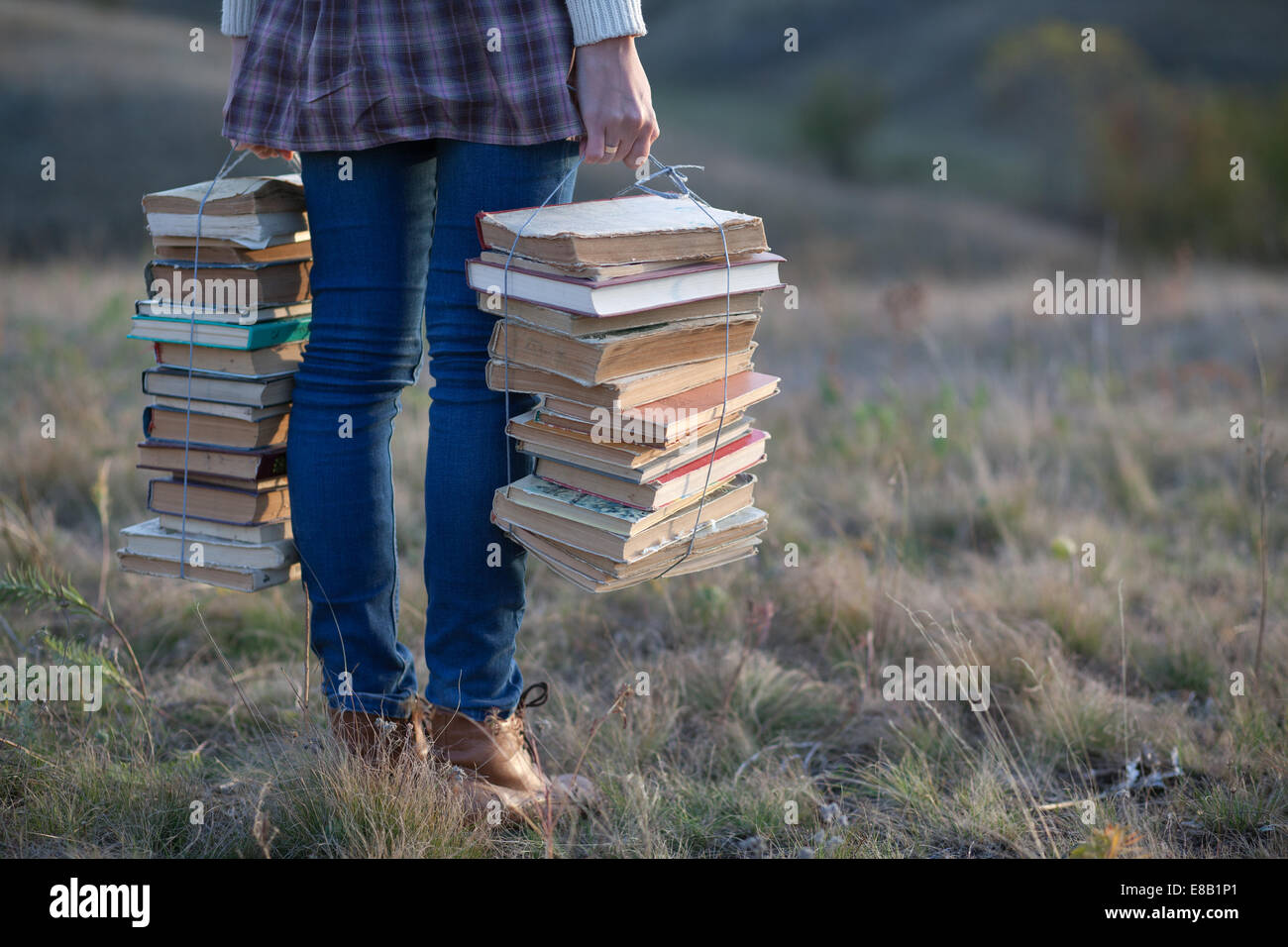 Girls hands holding books Stock Photo - Alamy