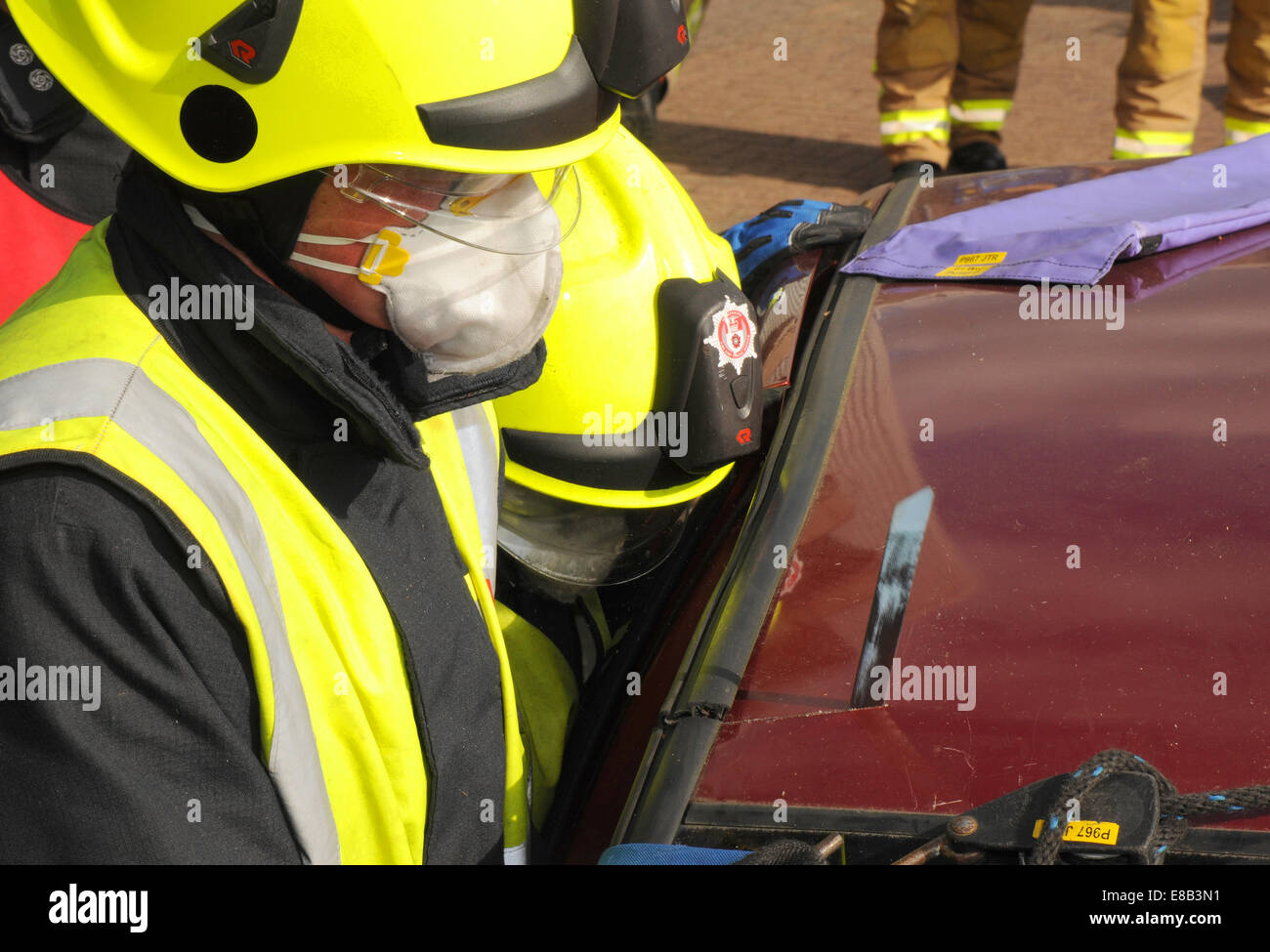 Fire service officer cutting the roof from a crashed car Suitable for ...