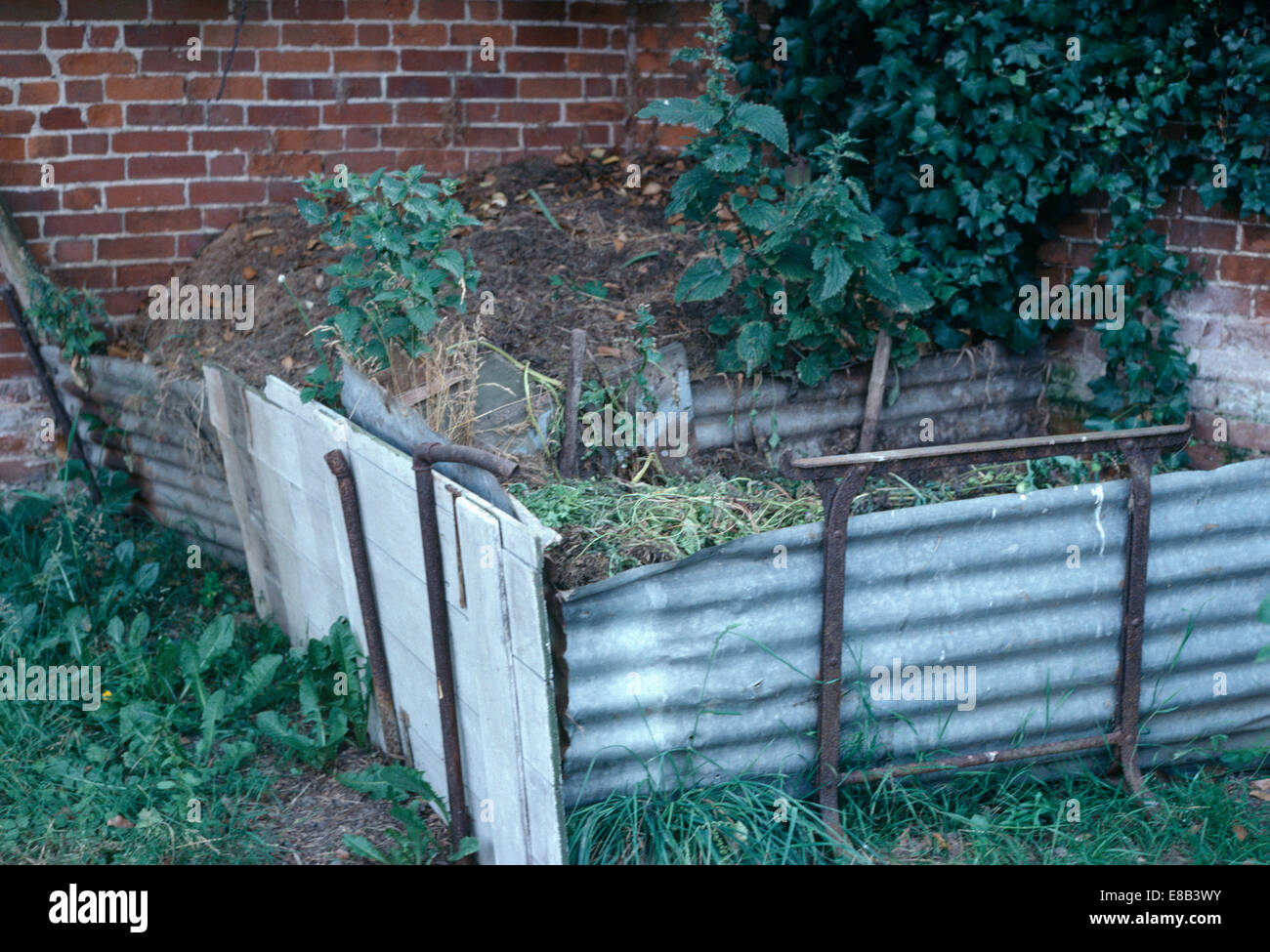 Compost heap lined with corrugated iron Stock Photo - Alamy