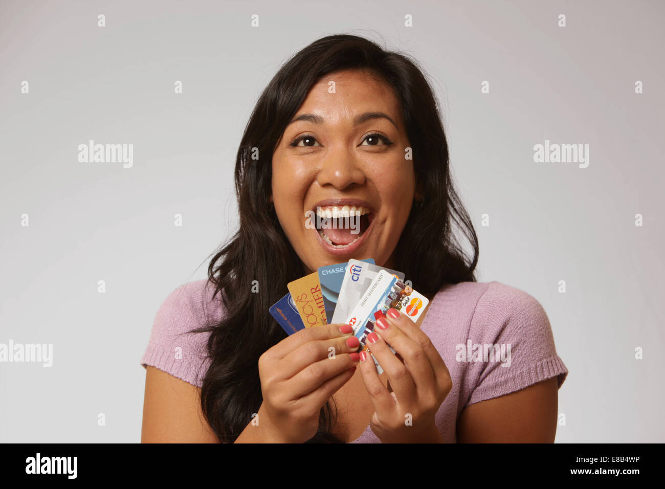 Beautiful woman feeling ecstatic while holding credit cards, New York ...