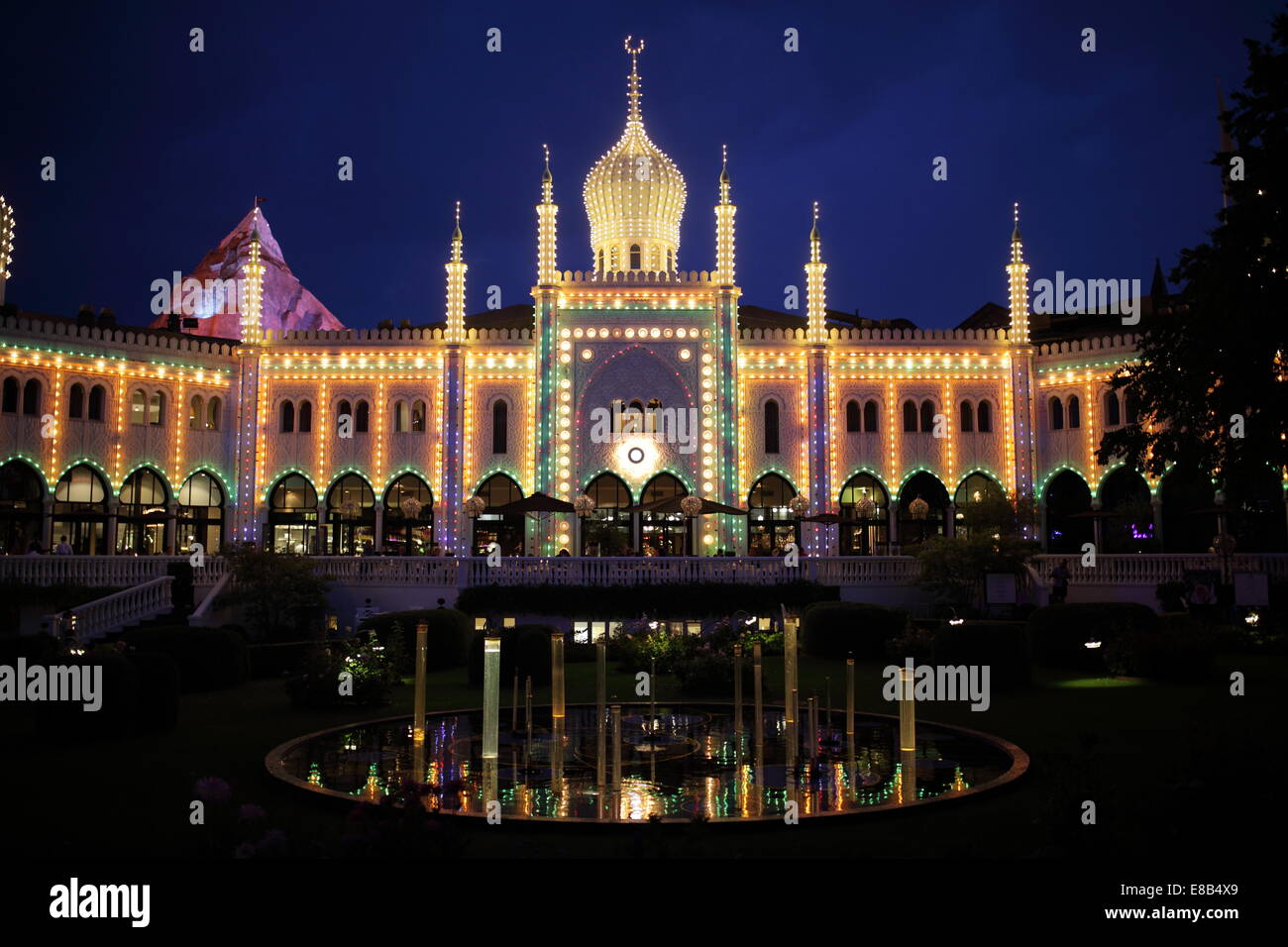 Eastern style building lit up at night in the Tivoli Gardens in ...