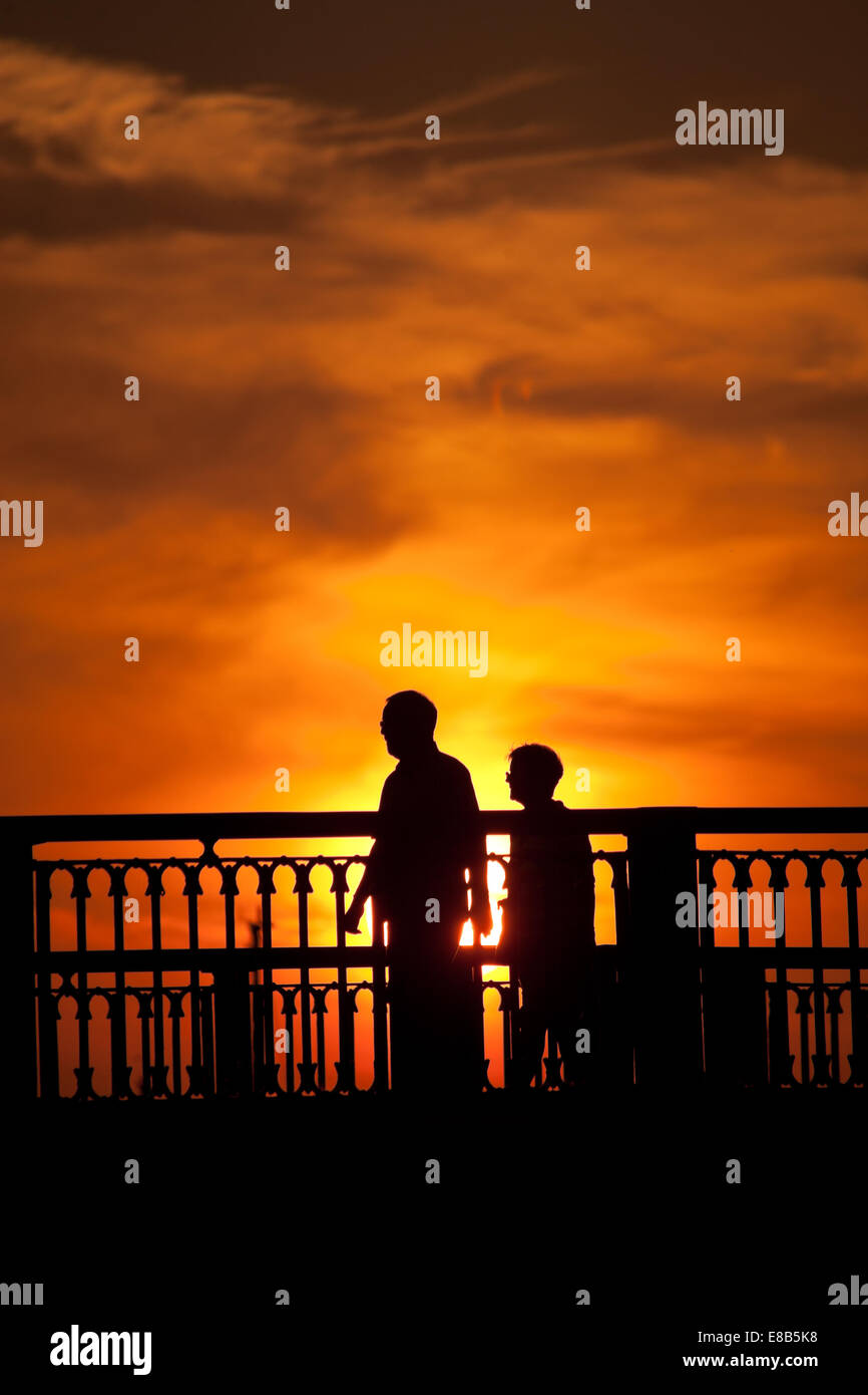 Two people standing on a bridge at sunset, Weymouth Dorset UK Stock ...