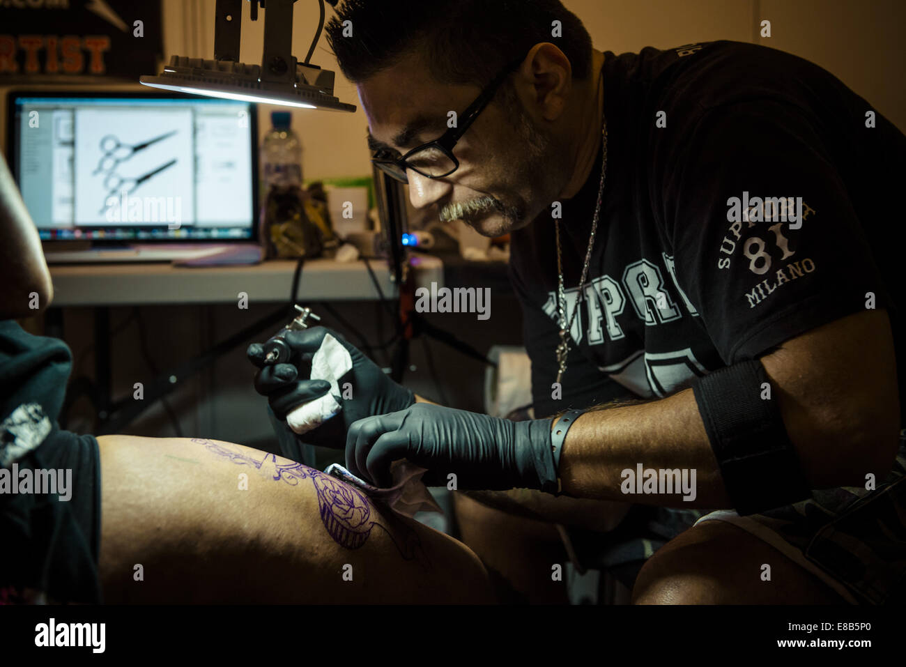 Tattoo artist STEFANO DEL POPOLO from Pelle Inkiostro, Italy, works on ...