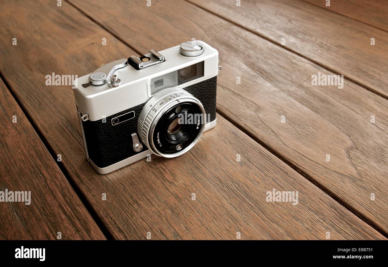 Analog camera on wooden table Stock Photo - Alamy