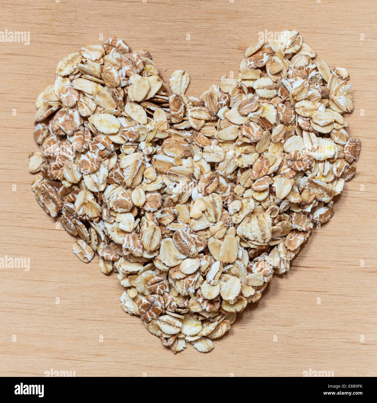 Dieting healthcare concept. Oat cereal heart shaped on wooden surface ...
