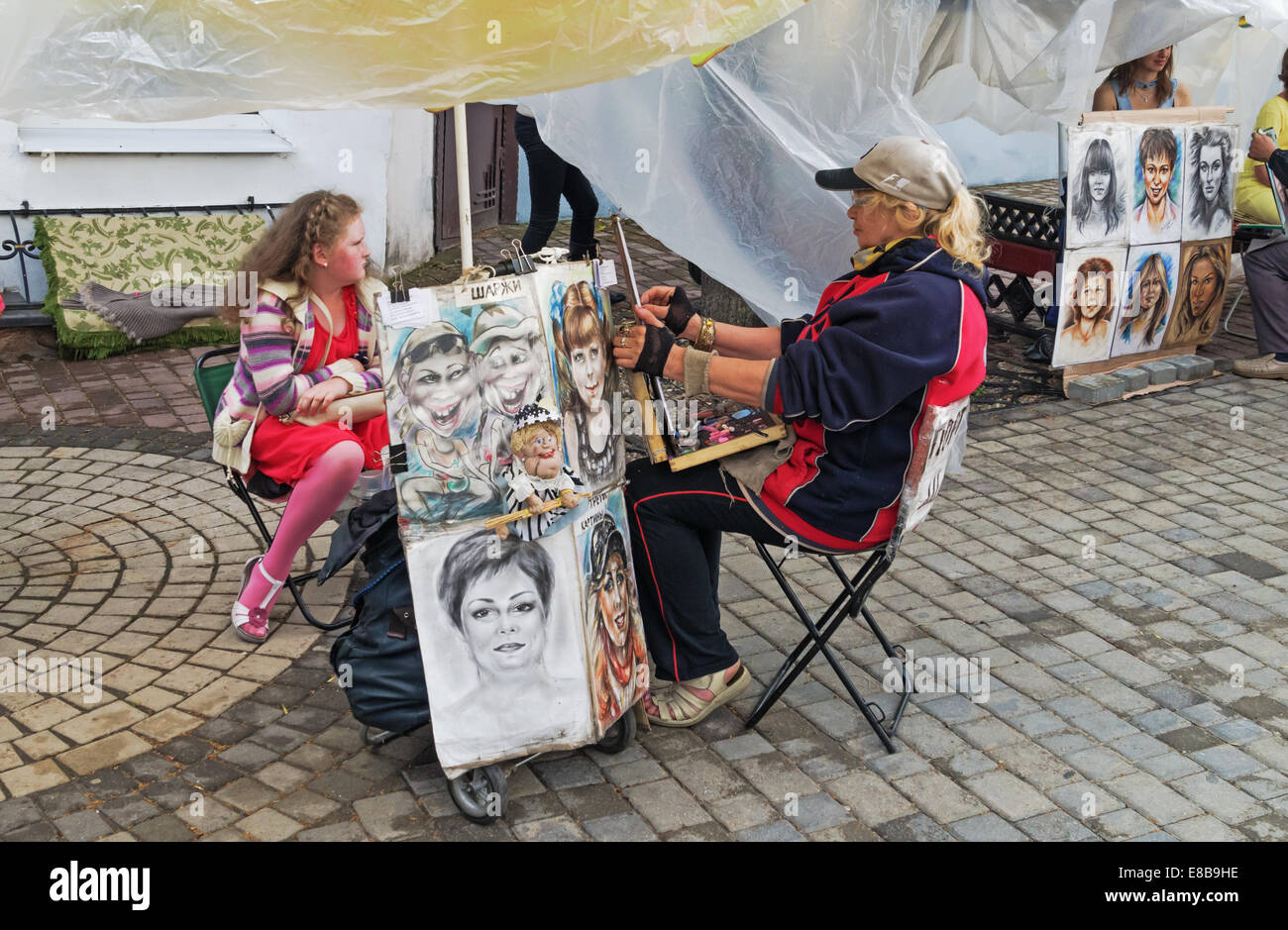 The street artists draw portraits on a pedestrian street Stock Photo ...