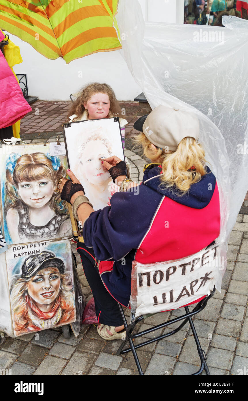 The street artists draw portraits on a pedestrian street Stock Photo ...