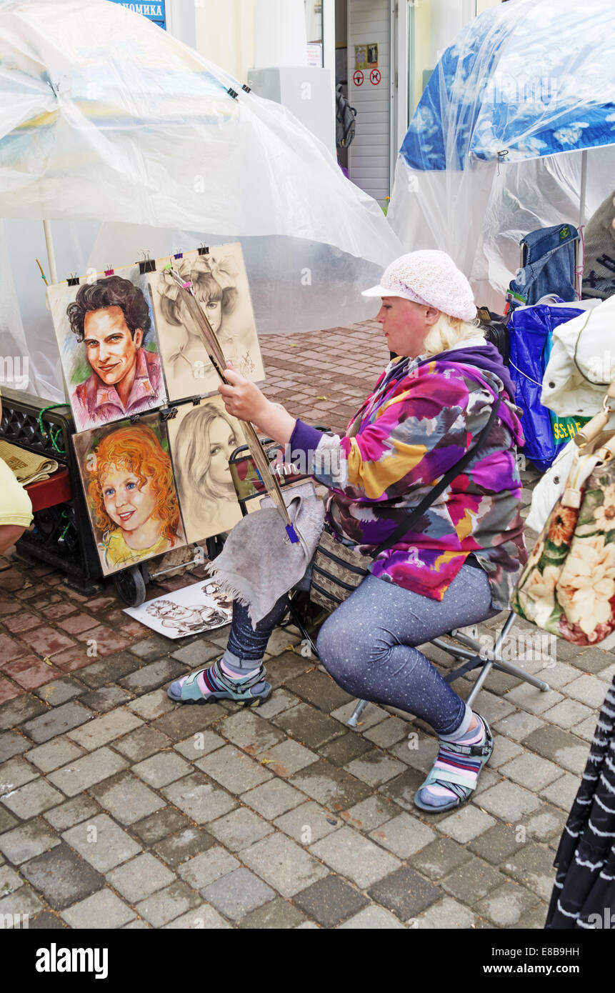 The street artists draw portraits on a pedestrian street Stock Photo ...
