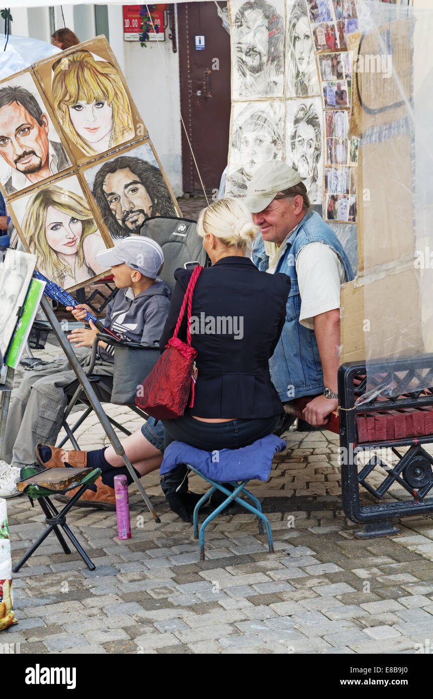 The street artists draw portraits on a pedestrian street Stock Photo ...