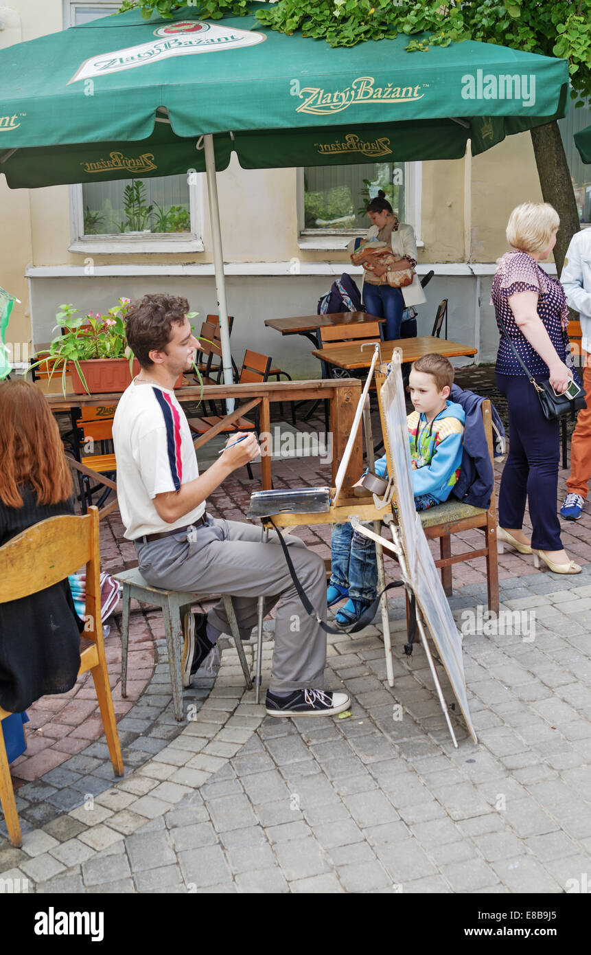 The street artists draw portraits on a pedestrian street Stock Photo ...