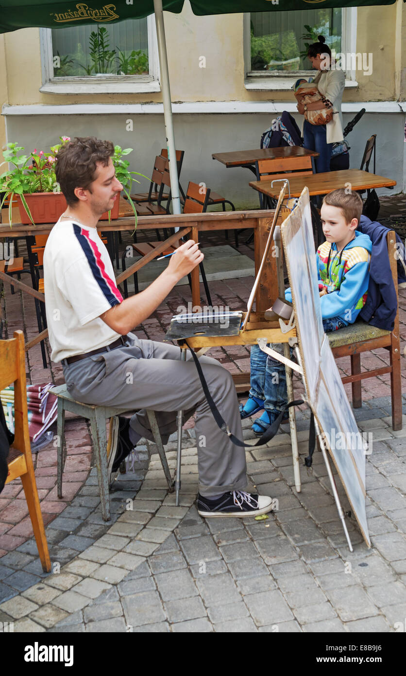 The street artists draw portraits on a pedestrian street Stock Photo ...
