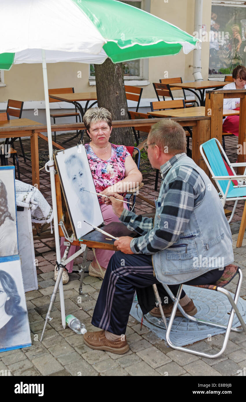 The street artists draw portraits on a pedestrian street Stock Photo ...