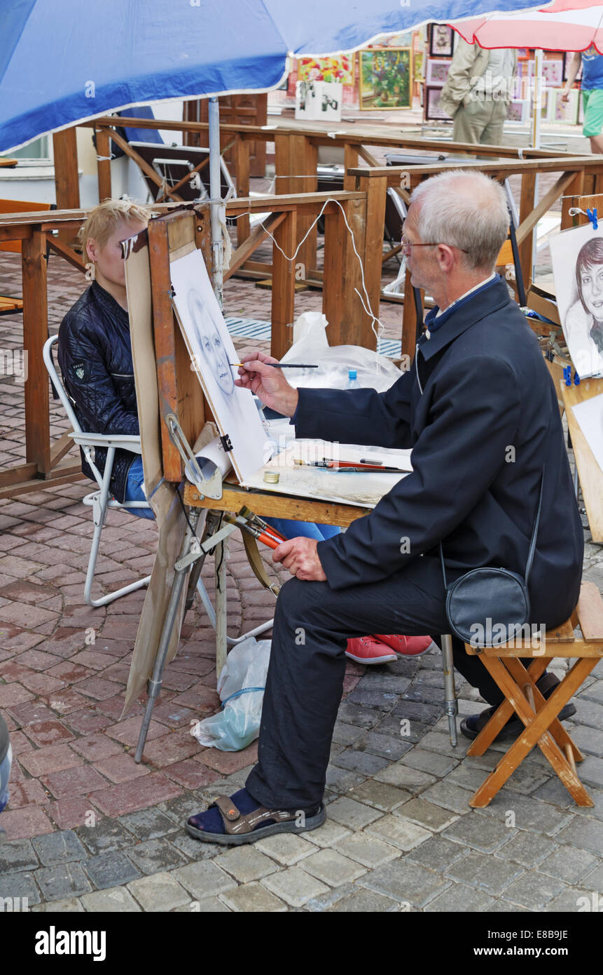 The street artists draw portraits on a pedestrian street Stock Photo ...